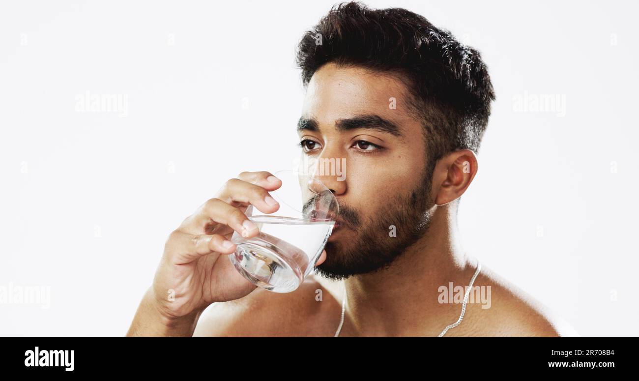 Man drinking water, hydration and health with serious face and glass in ...