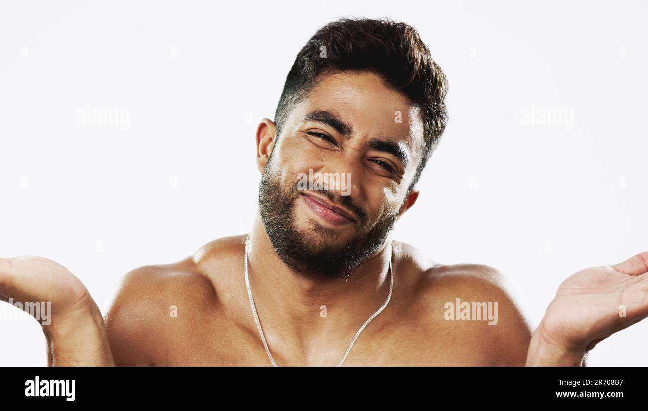 Uncertain confused and face of man in studio for wellness, skincare and ...