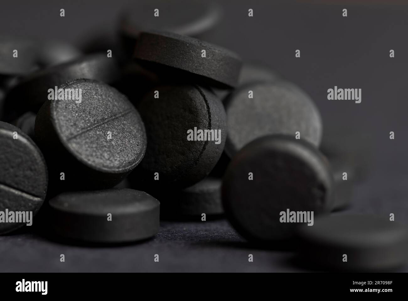 Open and unpacked tablets of black color close-up, a large number of ...