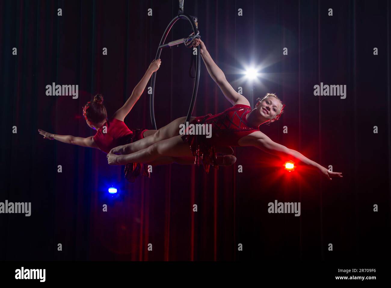 Circus acrobats gymnasts perform on a stage dark background Stock Photo ...
