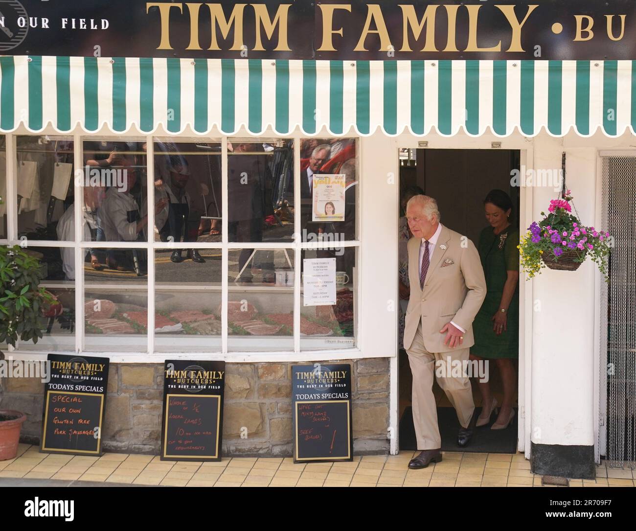 King Charles III leaves a family butchers shop during a visit to ...