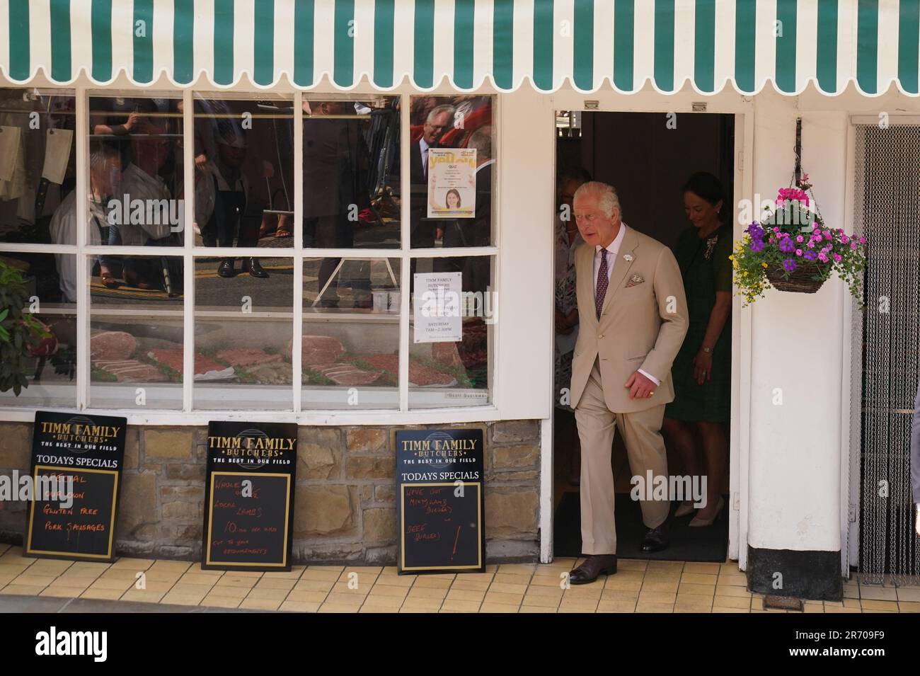 King Charles III leaves a family butchers shop during a visit to ...