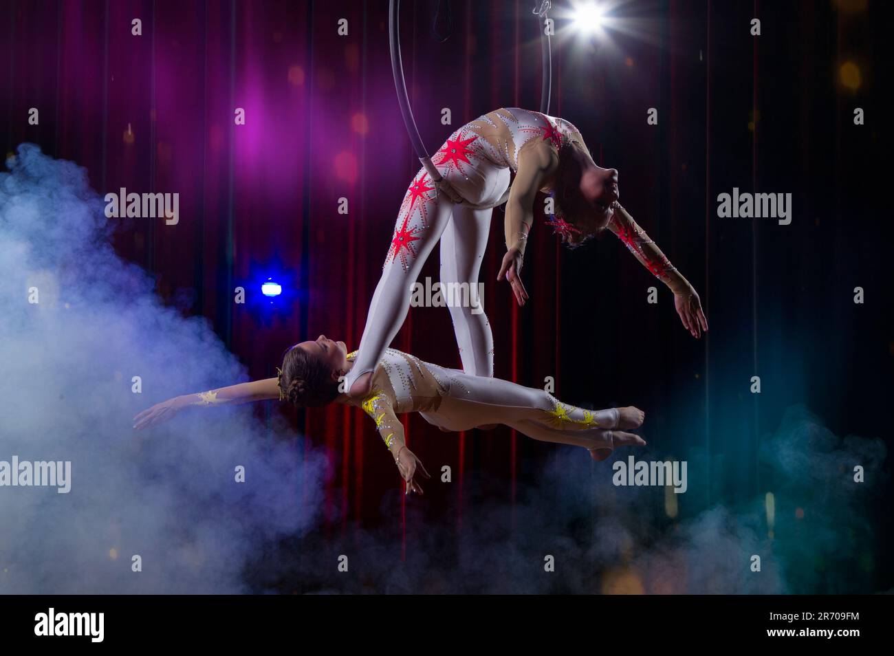 Circus acrobats gymnasts perform on a stage dark background Stock Photo ...