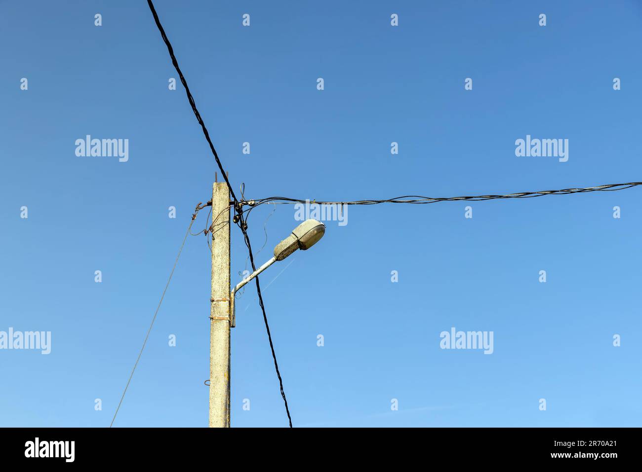 High-voltage power lines mounted on concrete poles, metal wires on ...