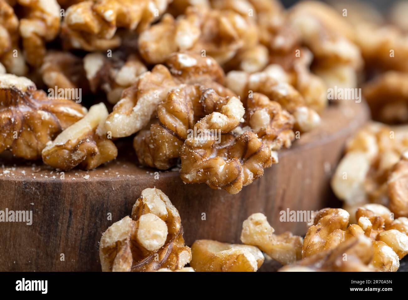 Peeled walnuts, walnut kernel on the kitchen table during cooking Stock ...