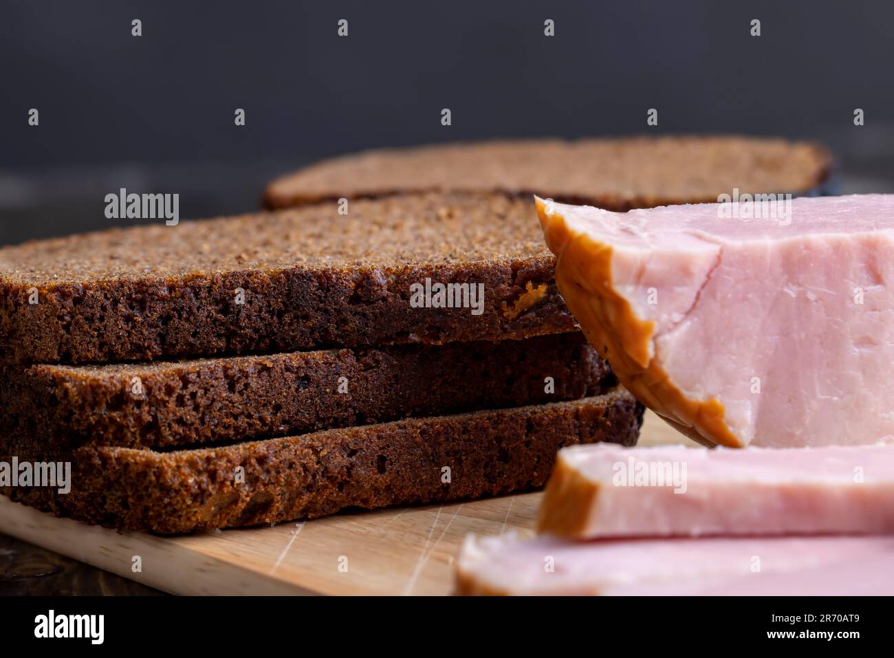 A sliced piece of delicious pork meat , ready made meat food on a board ...