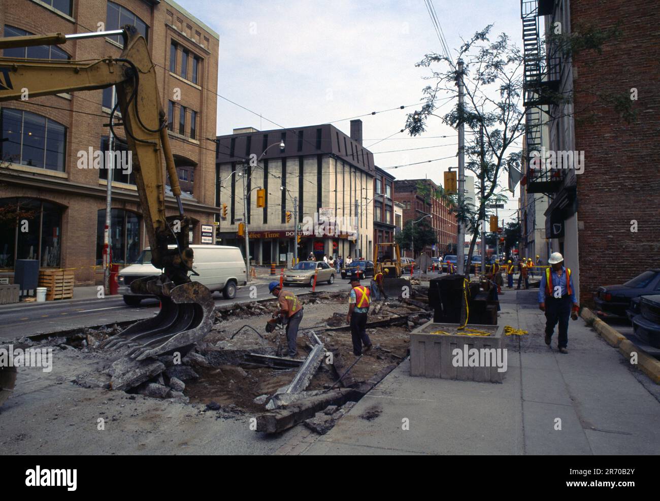 Toronto Ontario Canada Construction Workers Digger Digging up Road ...