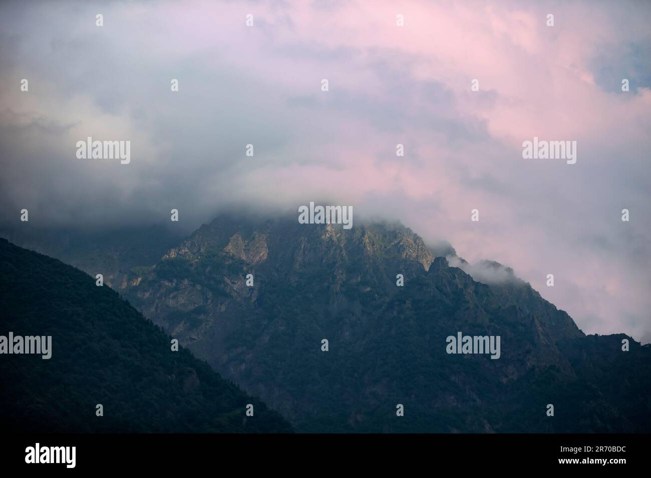 Dark atmospheric surreal landscape with a dark rocky mountain peak in ...