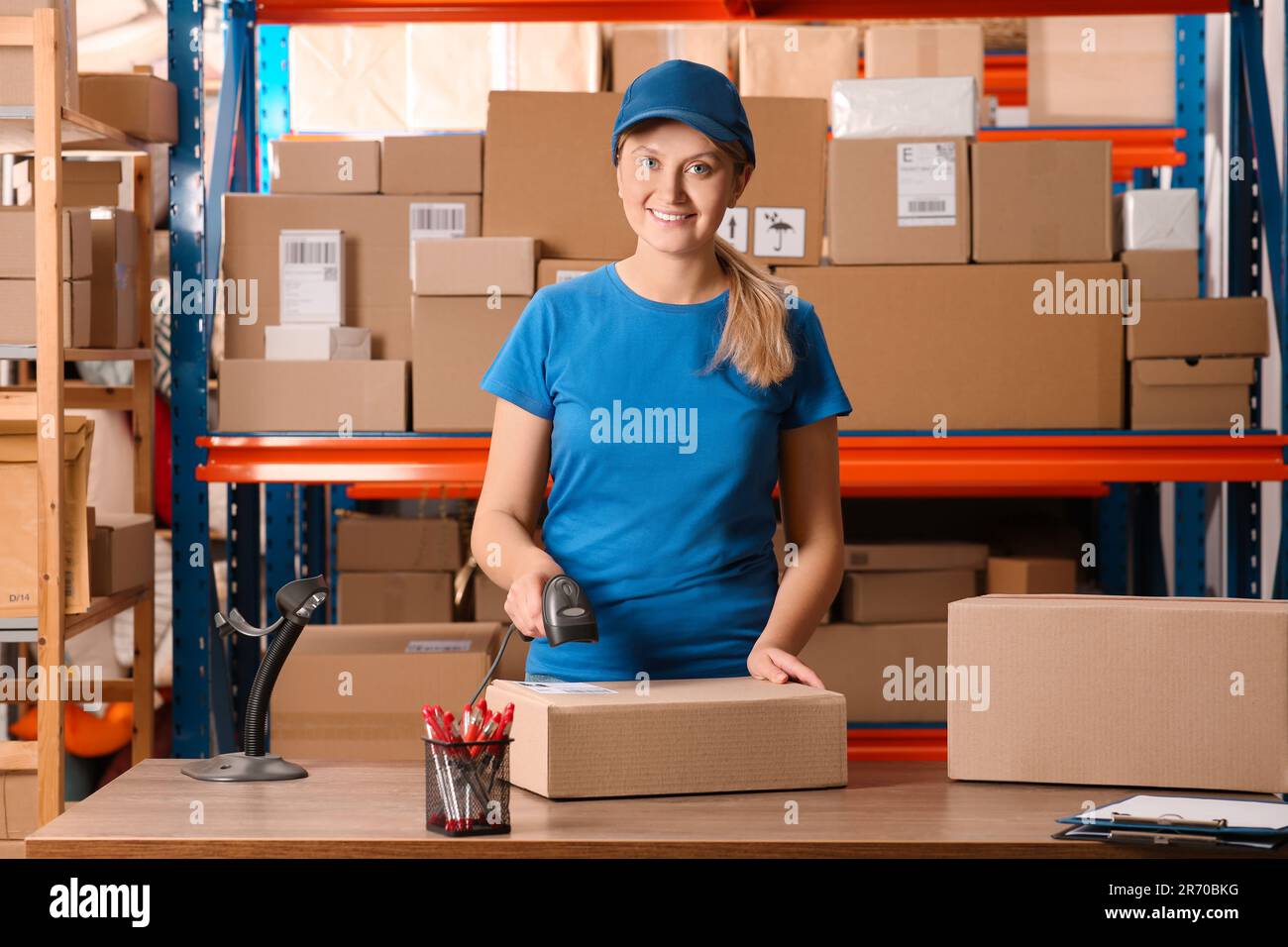 Post office worker with scanner reading parcel barcode at counter Stock ...
