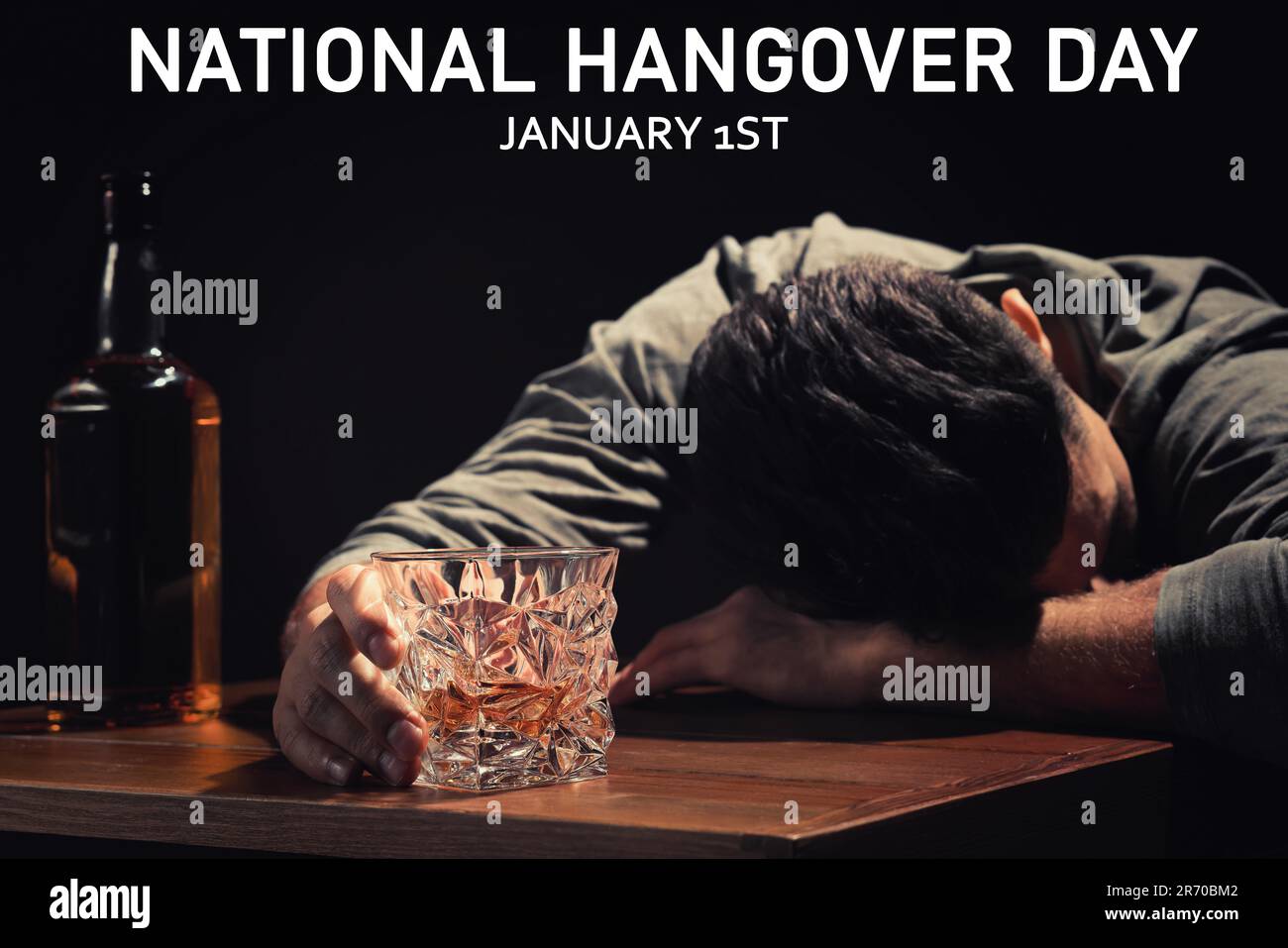 National hangover day - January 1st. Man holding glass of alcoholic ...