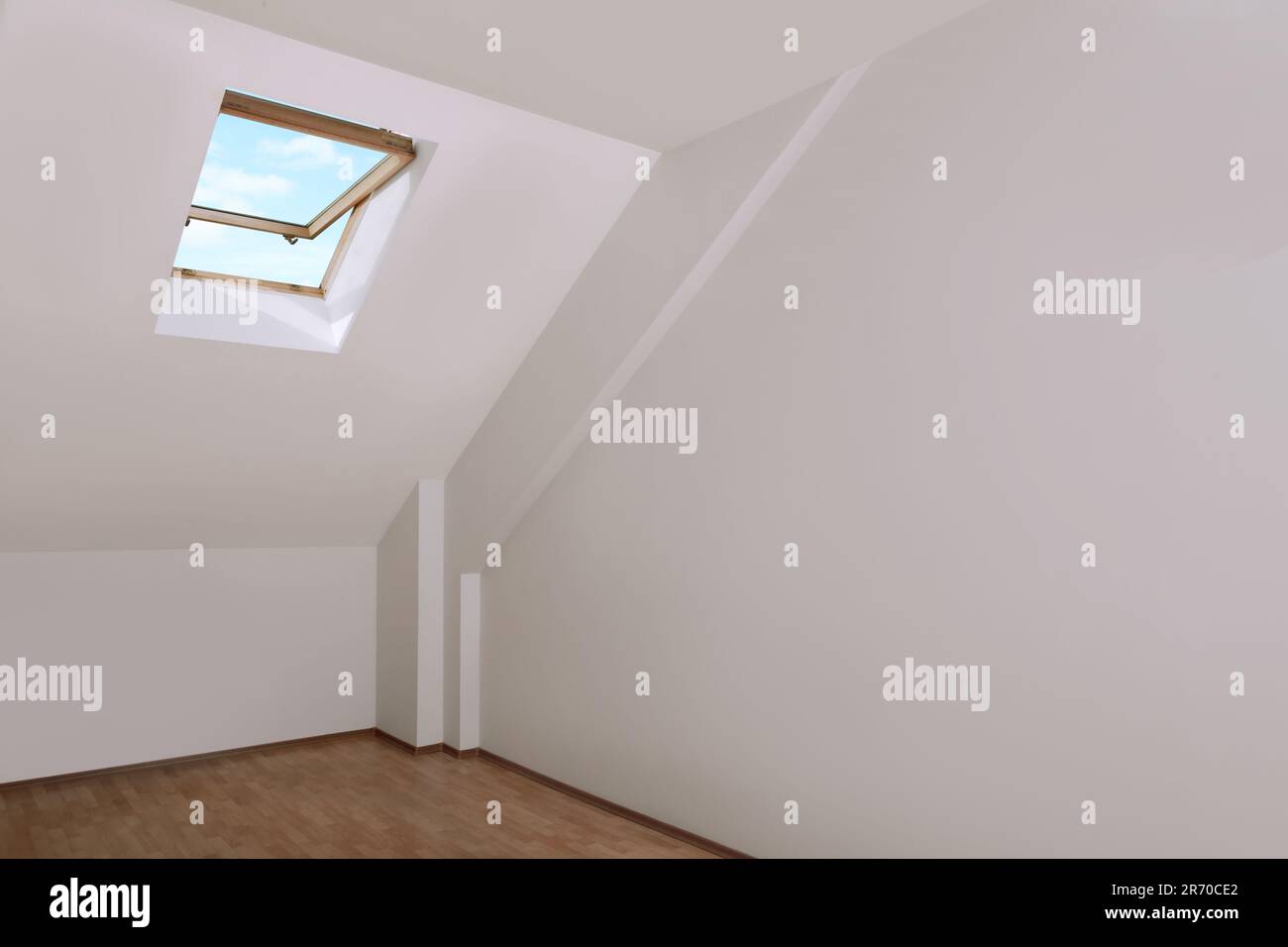 Light spacious attic room with roof window on slanted ceiling Stock ...