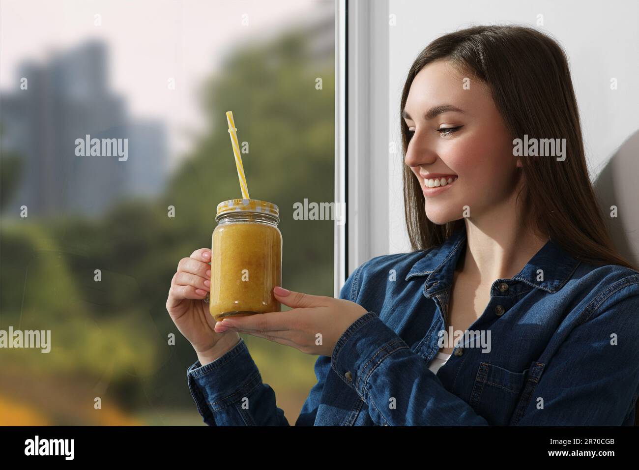 Beautiful young woman with delicious smoothie near window Stock Photo ...