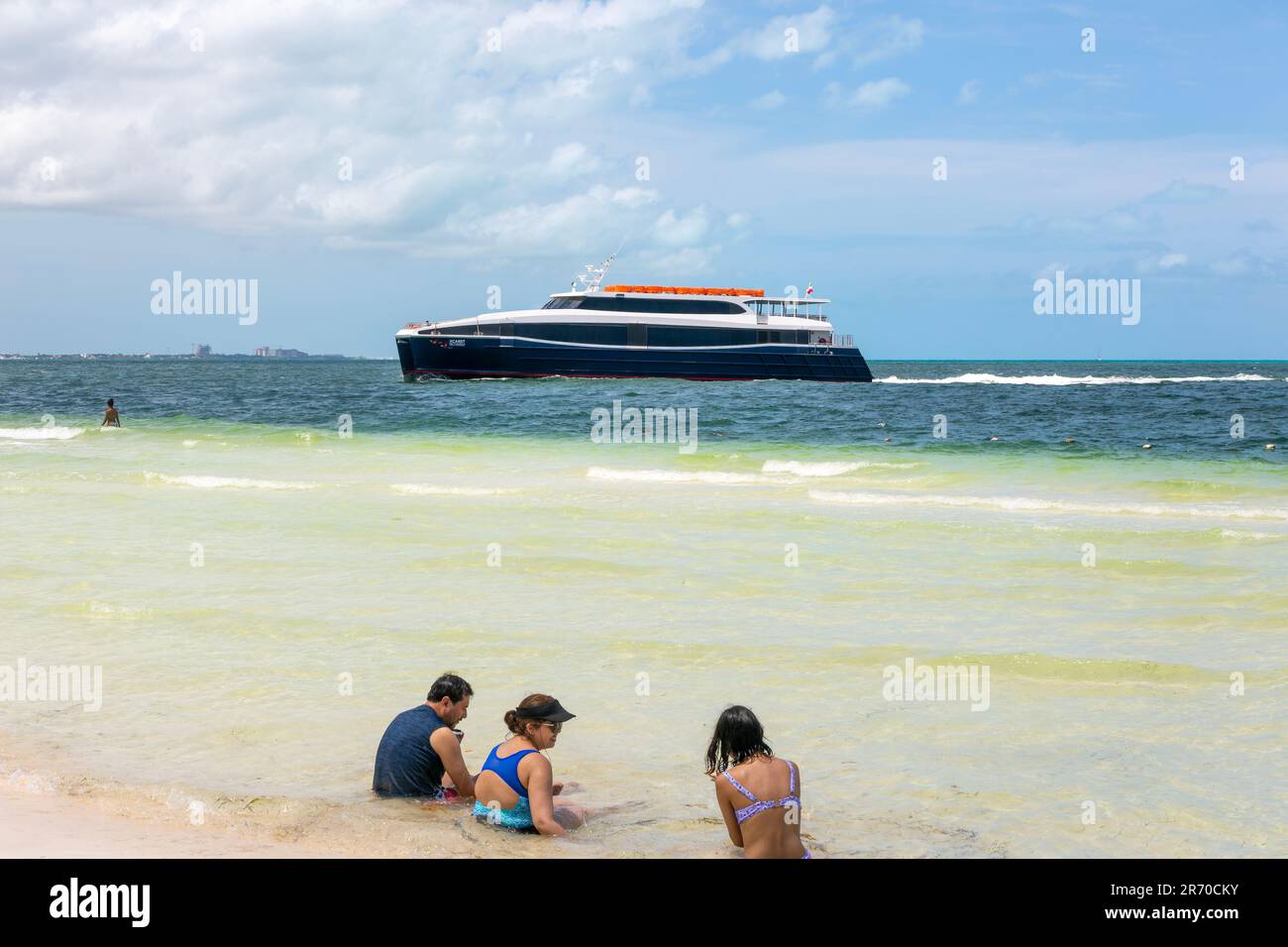 XCaret ferry boat from Isla Mujeres with people sitting in sea, Cancun ...
