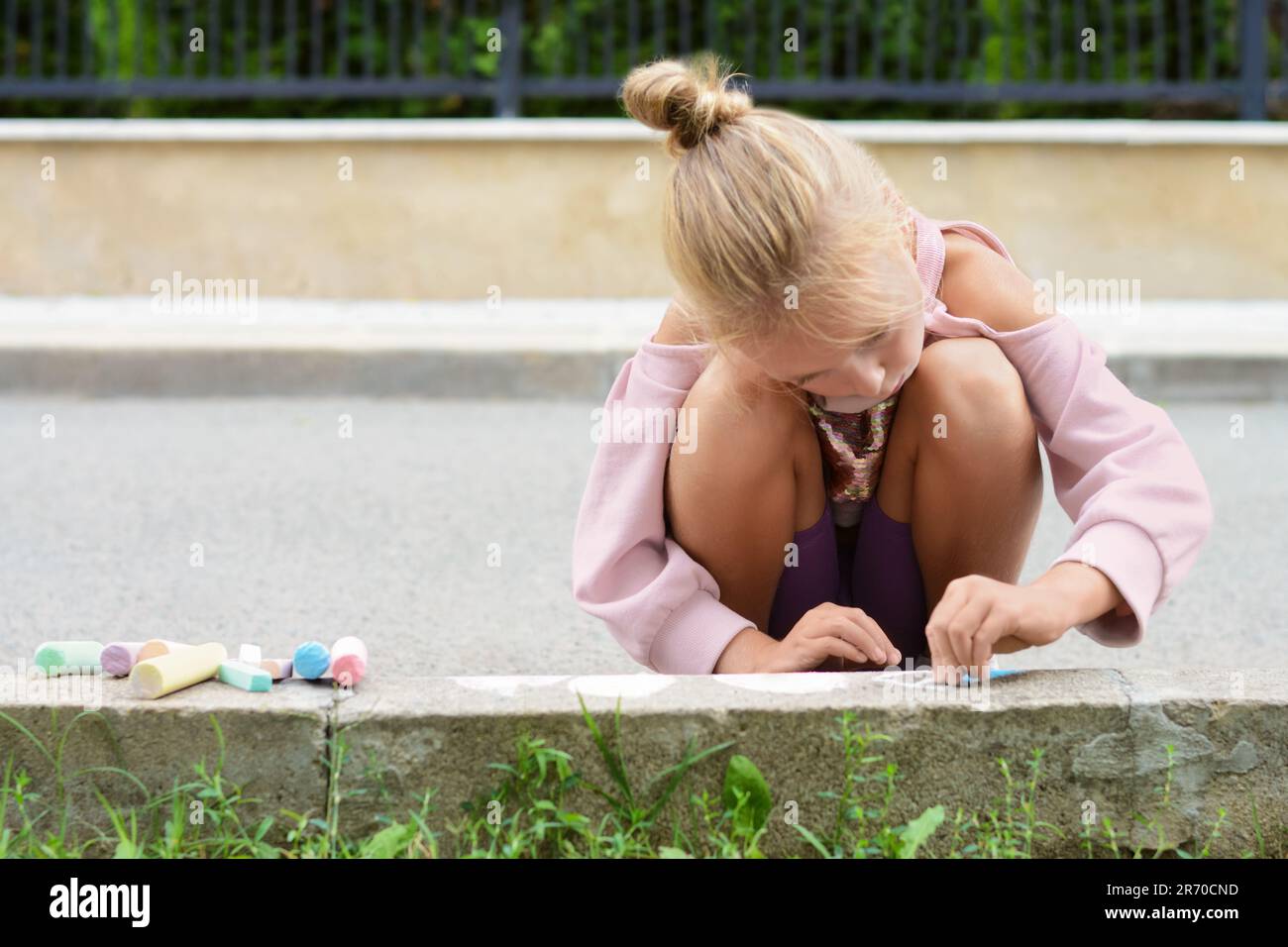 Little child drawing with chalk on curb outdoors, space for text Stock Photo - Alamy