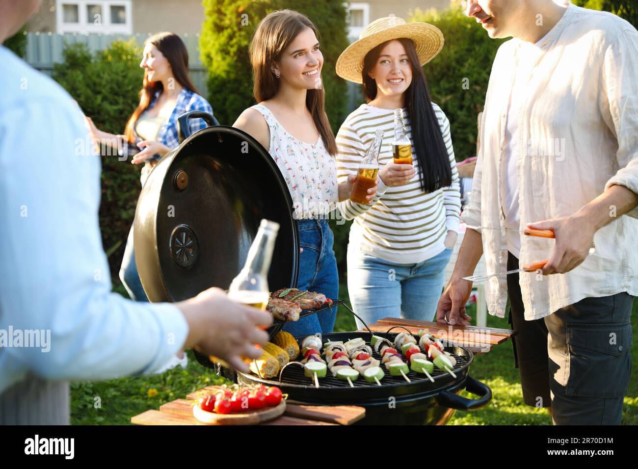 Group of friends having barbecue party outdoors Stock Photo - Alamy
