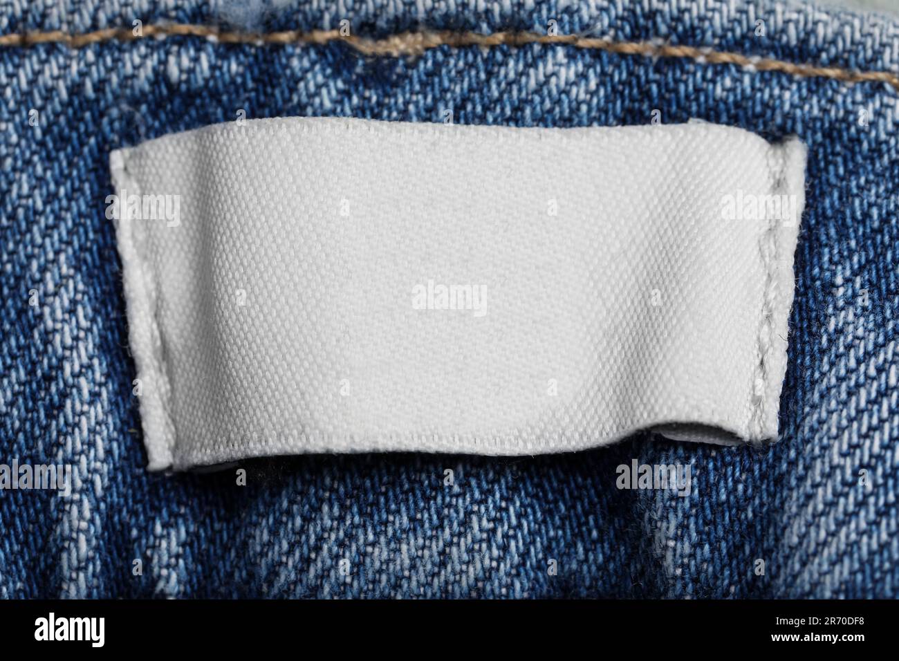 Empty clothing label on jeans garment, top view Stock Photo - Alamy