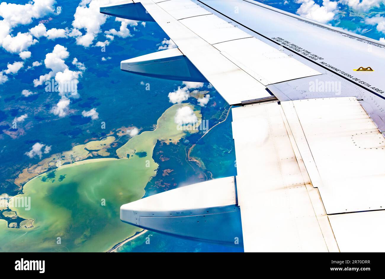 Oblique angle aerial view through plane window over Laguna Chunyaxché ...