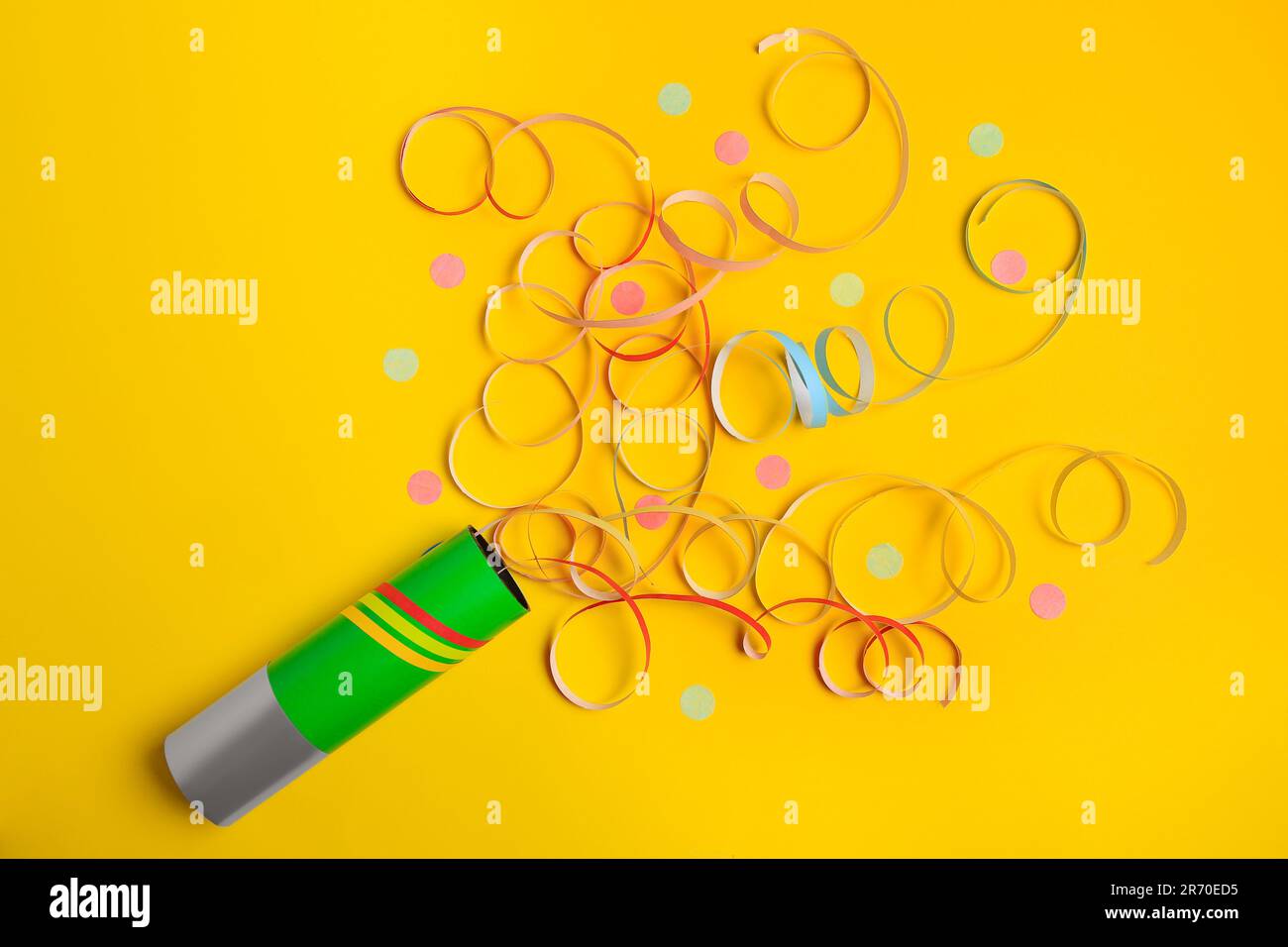 Beautiful serpentine and confetti bursting out of party popper on ...