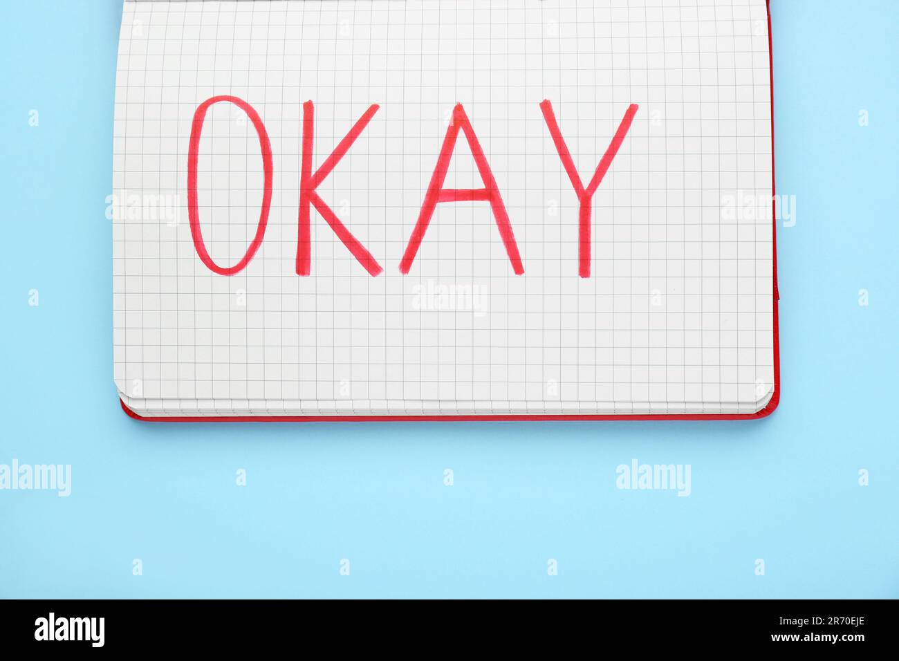 Notebook with word Okay on light blue background, top view Stock Photo ...