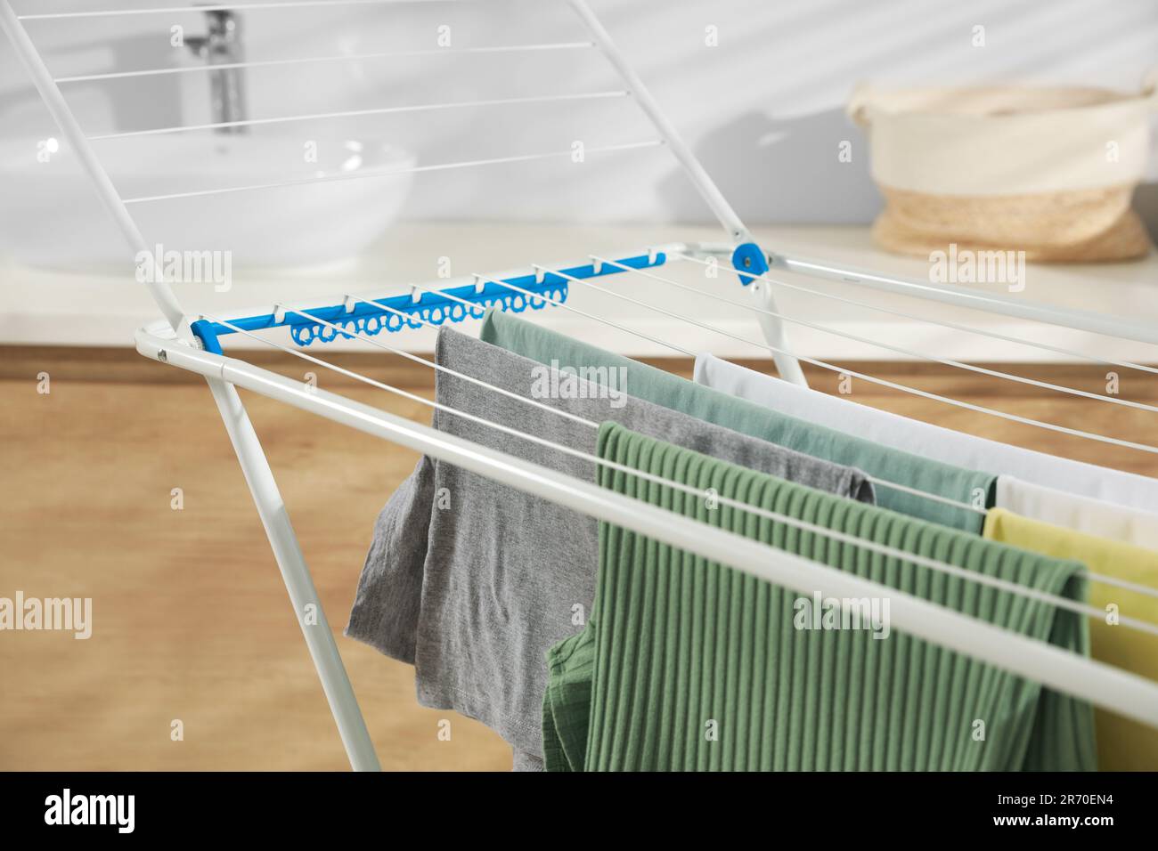 Different apparel drying on clothes airer in bathroom Stock Photo - Alamy