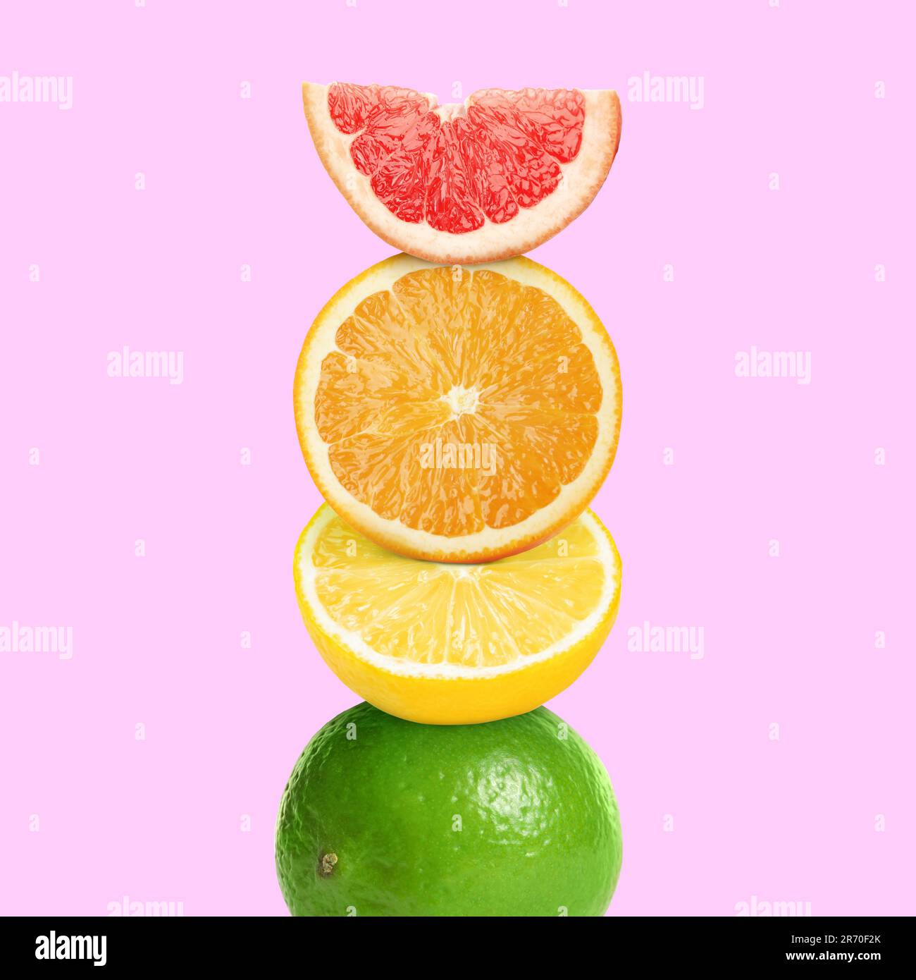 Stack of different fresh citrus fruits on pale pink background Stock ...