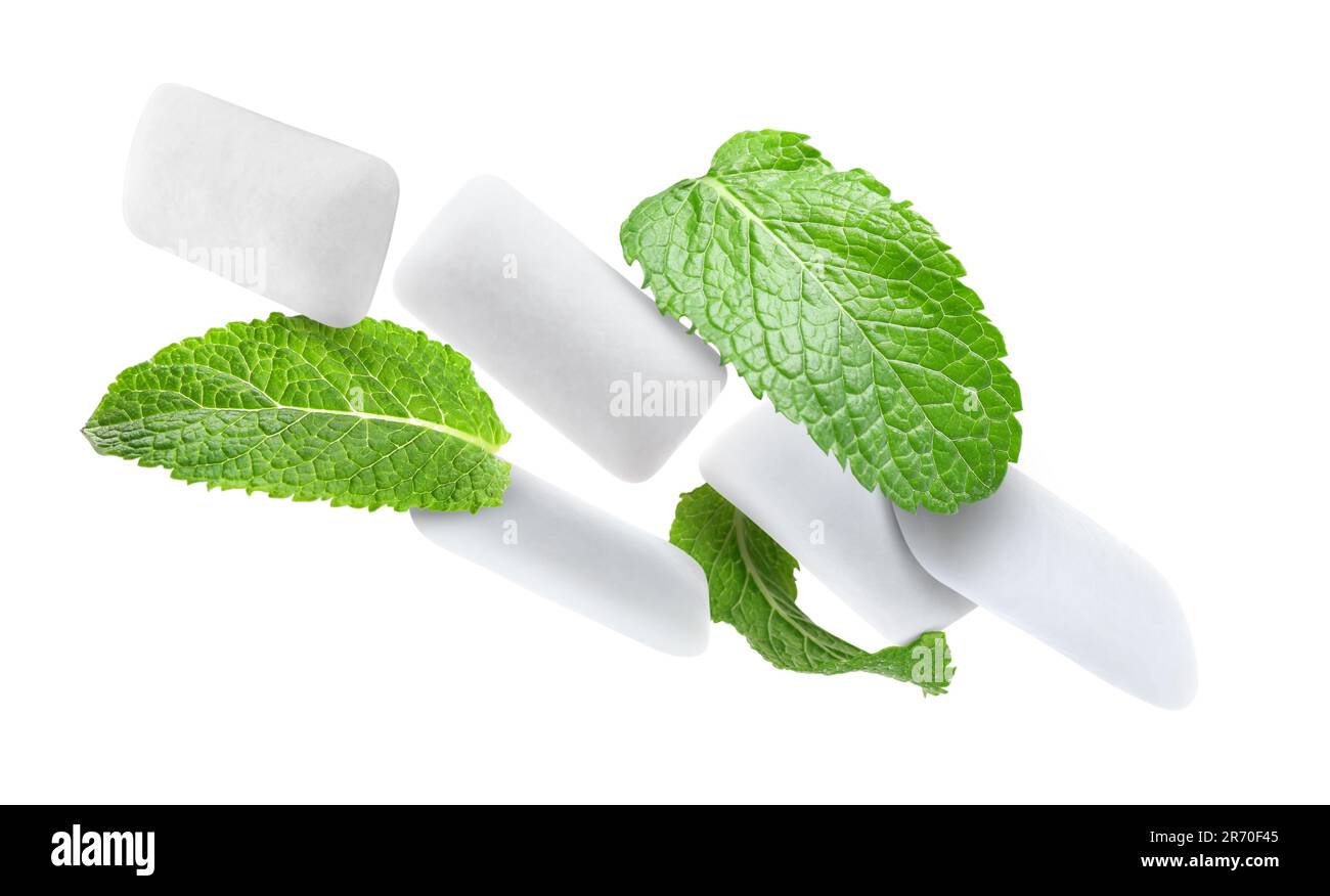 Fresh mint leaves and chewing gum pads falling on white background ...