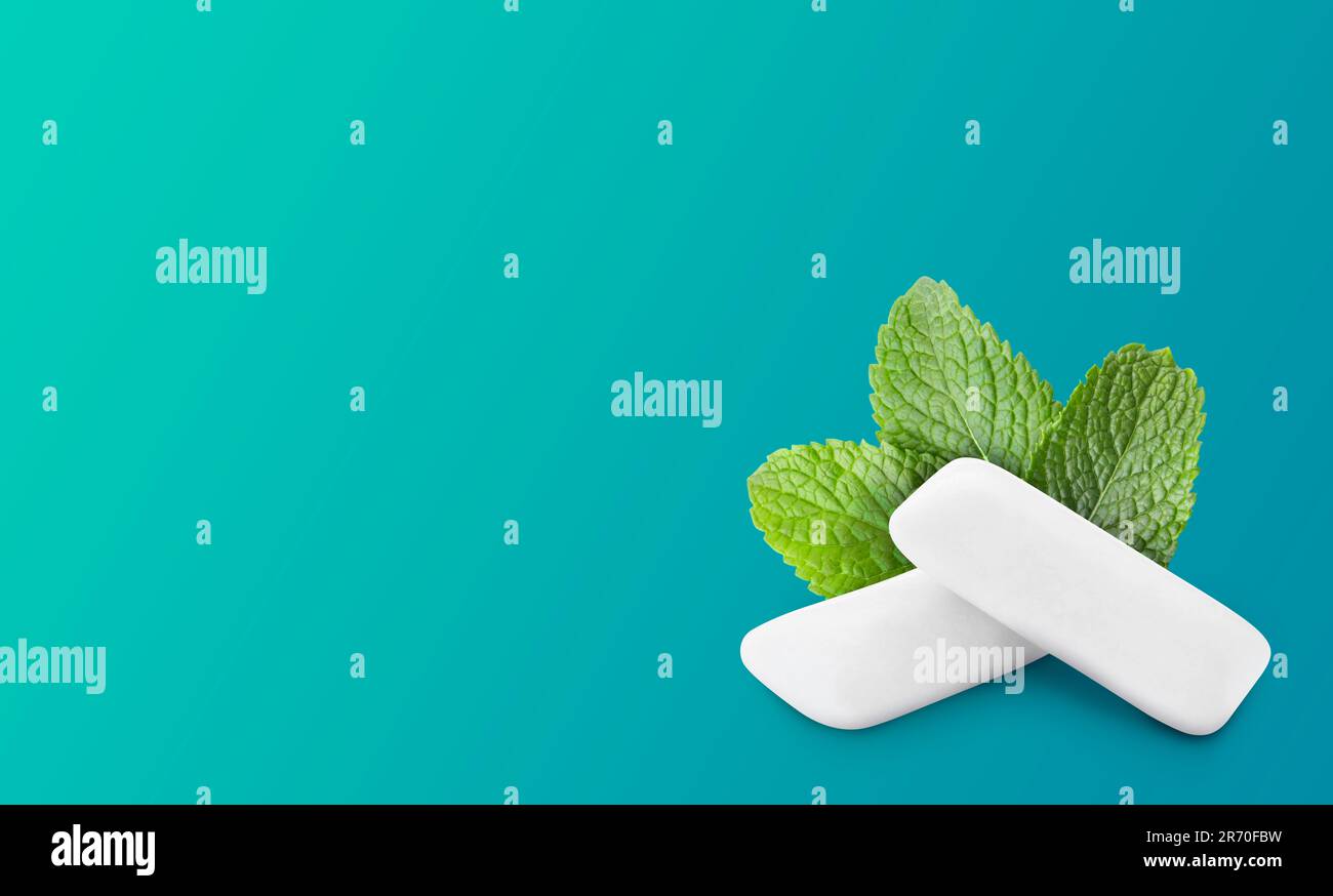 Menthol chewing gum pillows and mint leaves on blue gradient background ...