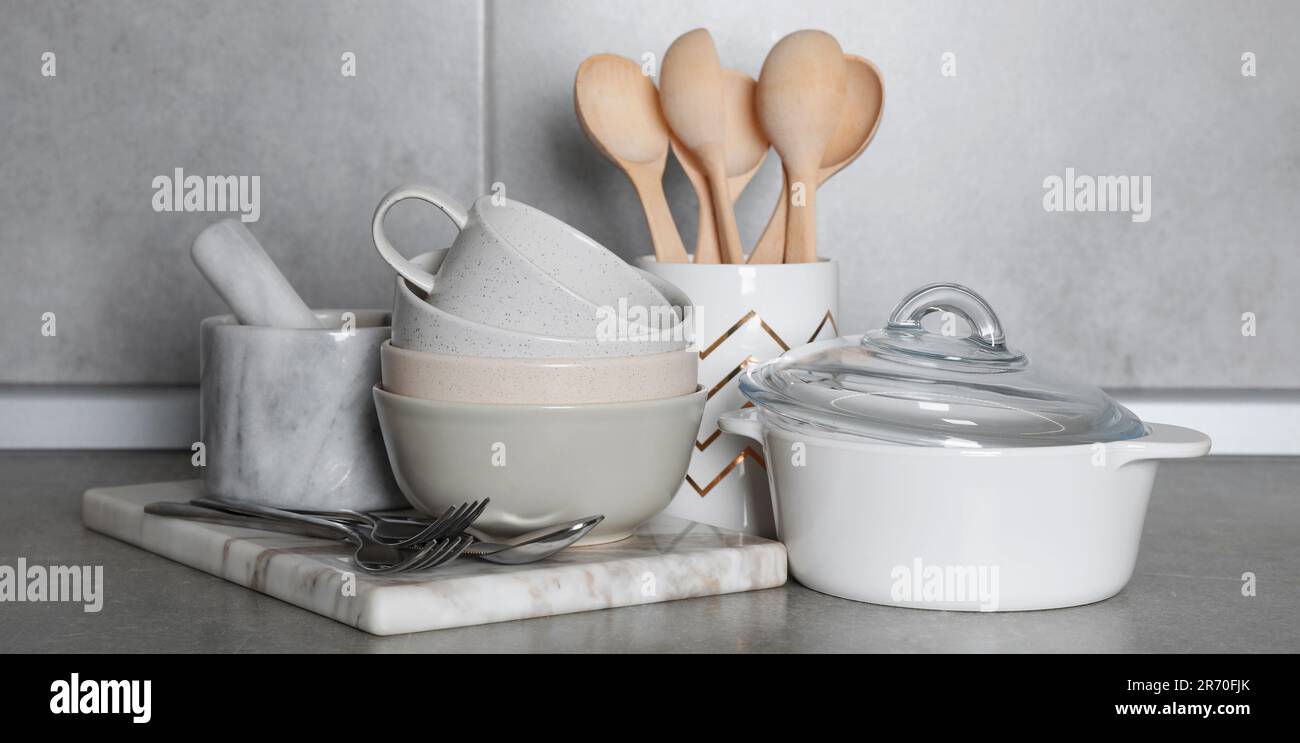 Set of cooking utensils and cookware on grey countertop in kitchen ...