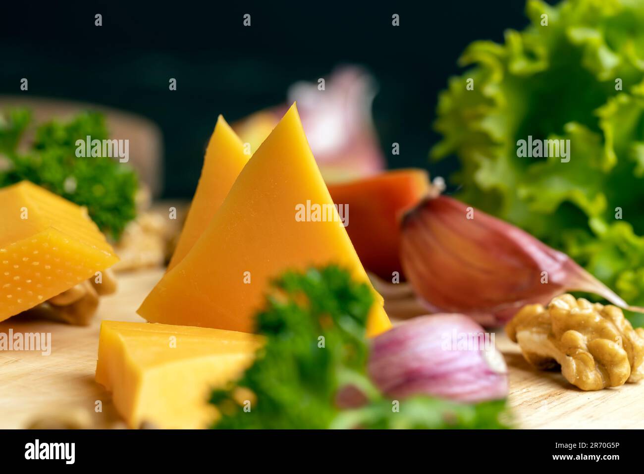 Sliced hard cheese made from milk, real aged yellow cheese on a board ...