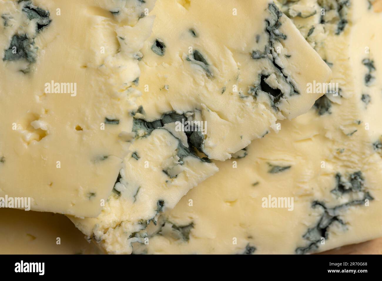 Cheese with blue mold cut into pieces, slices of cheese with blue noble ...