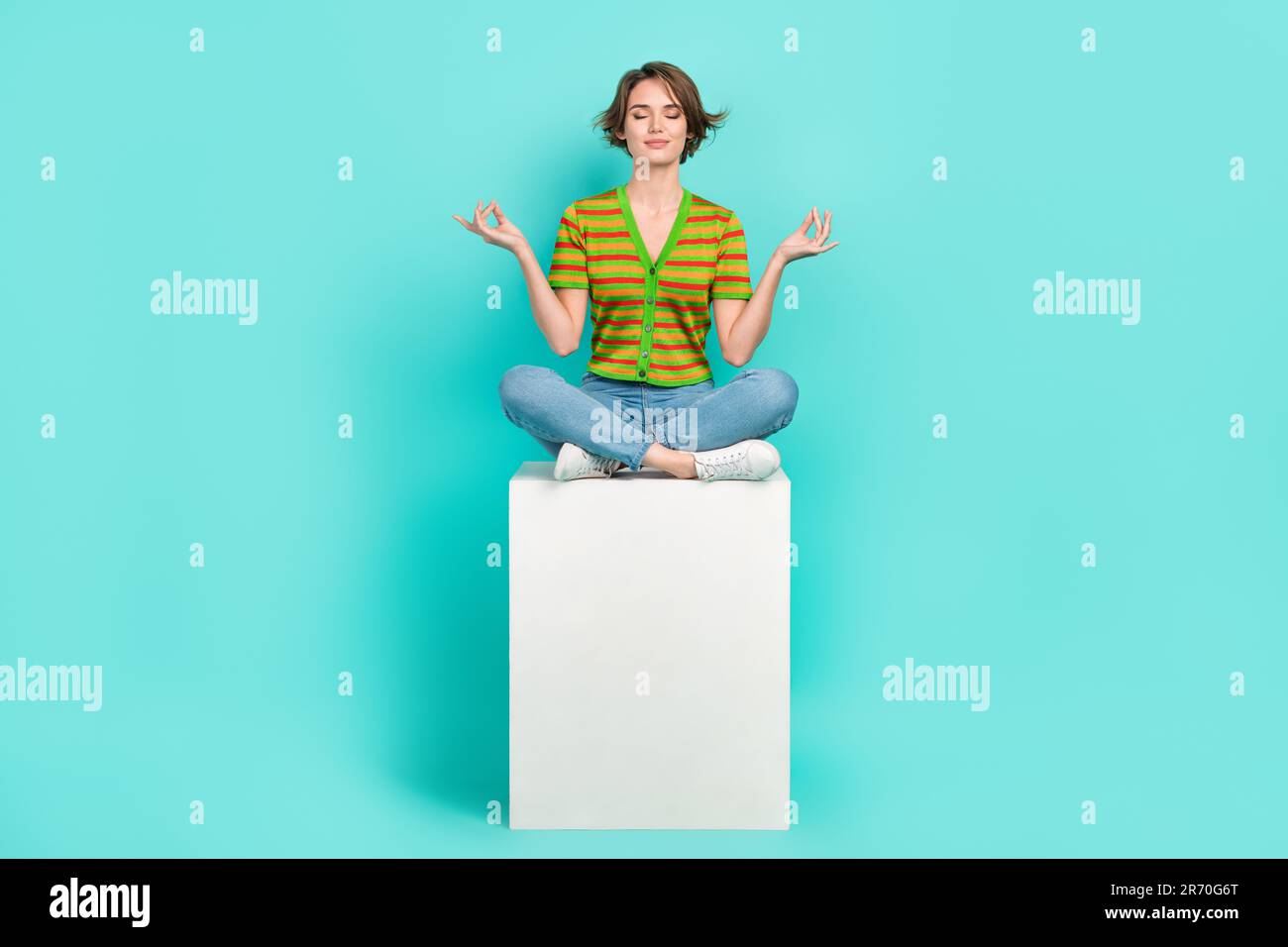 Full length photo of calm peaceful person sit podium cube meditate ...