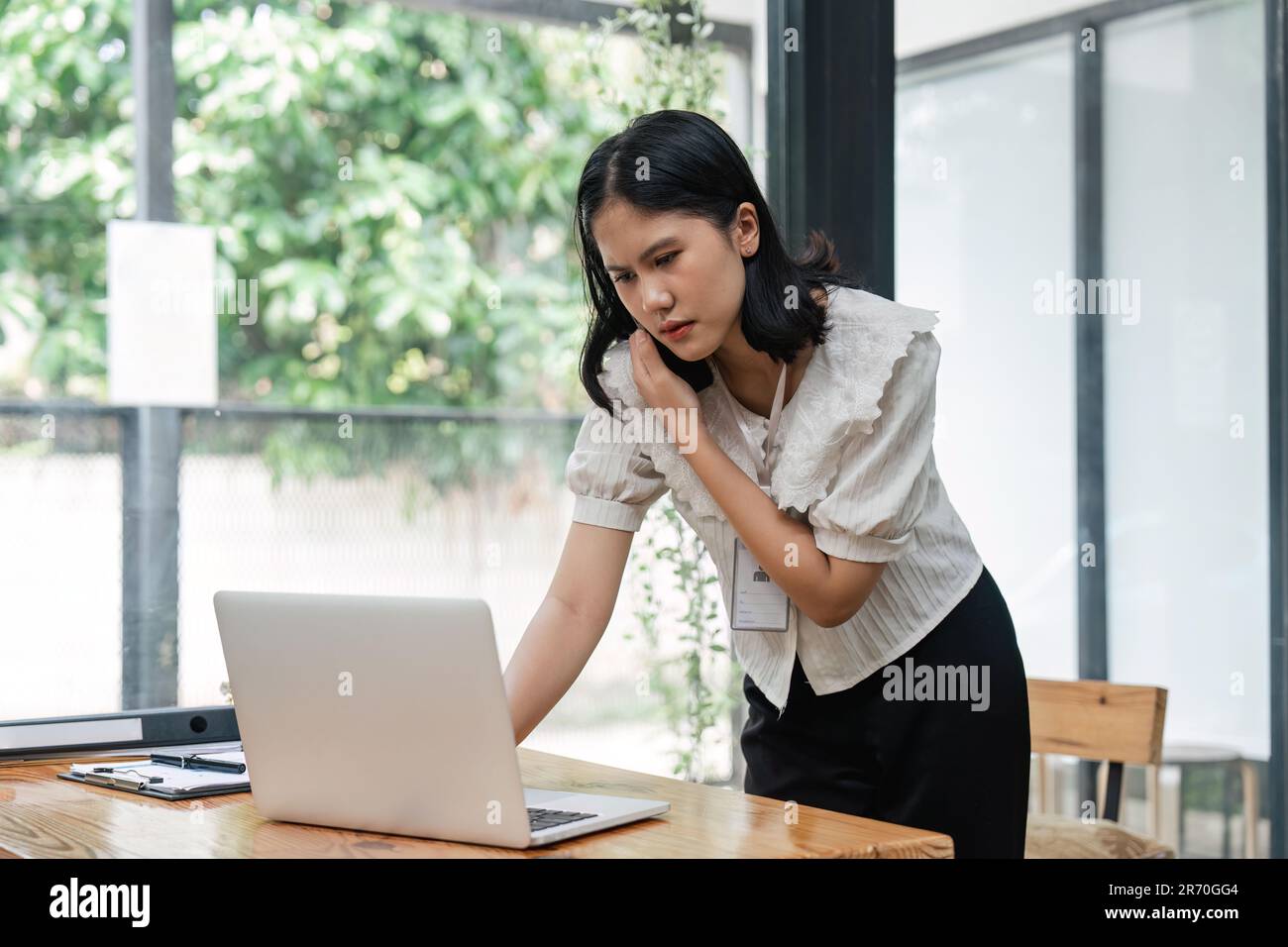 Stressed Asian businesswoman or female employee having a serious phone ...