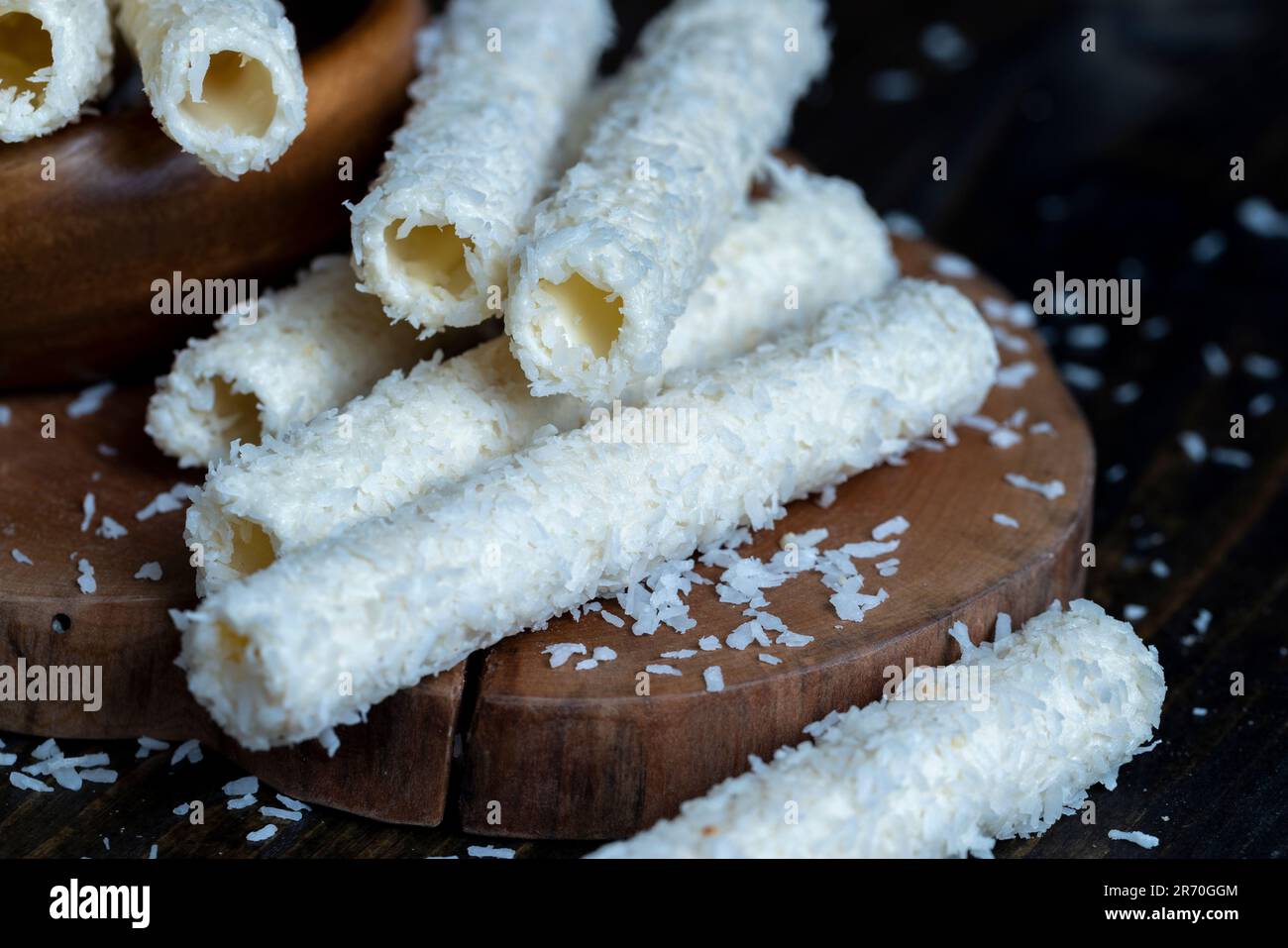 Waffle tubes with butter cream and coconut sprinkles, sweet waffle ...