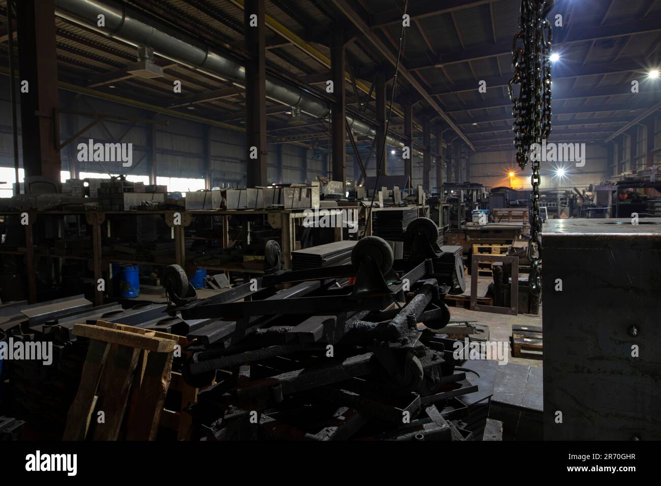 The metalworking shop of a factory in developing countries is dark and ...