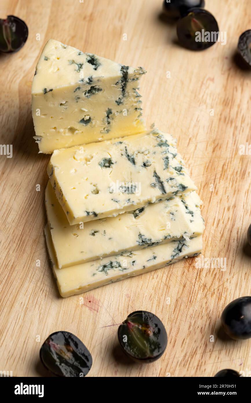 Cheese with blue mold cut into pieces, slices of cheese with blue noble ...