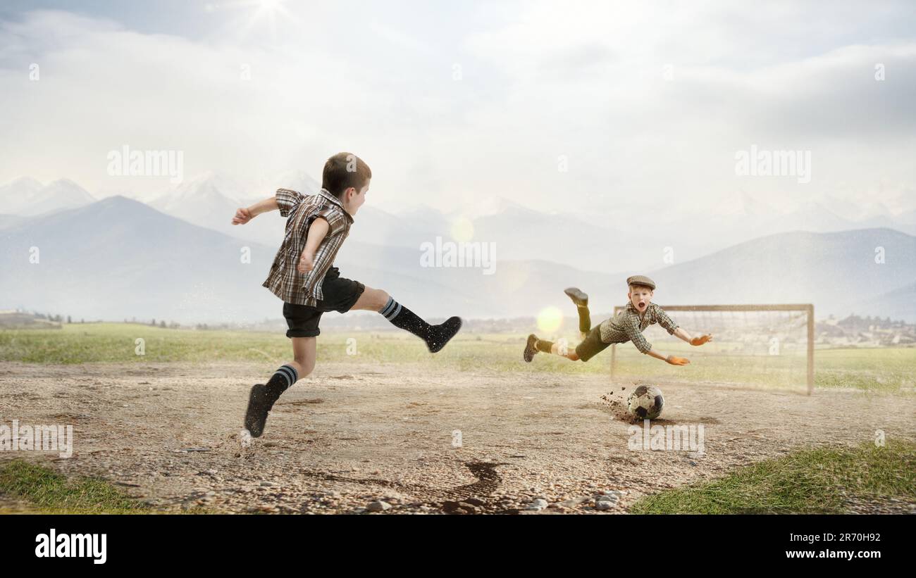 Dynamic image. Winning goal. Two little boys, children in retro style clothes playing football ...