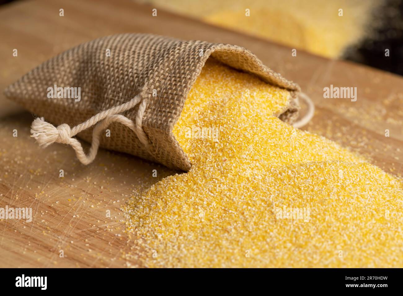 Dry corn flour poured into a linen bag for making porridge, high ...
