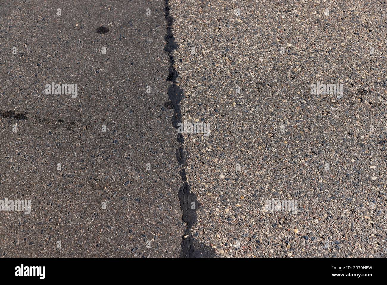 The repaired part of an asphalt road with patches, repair and ...