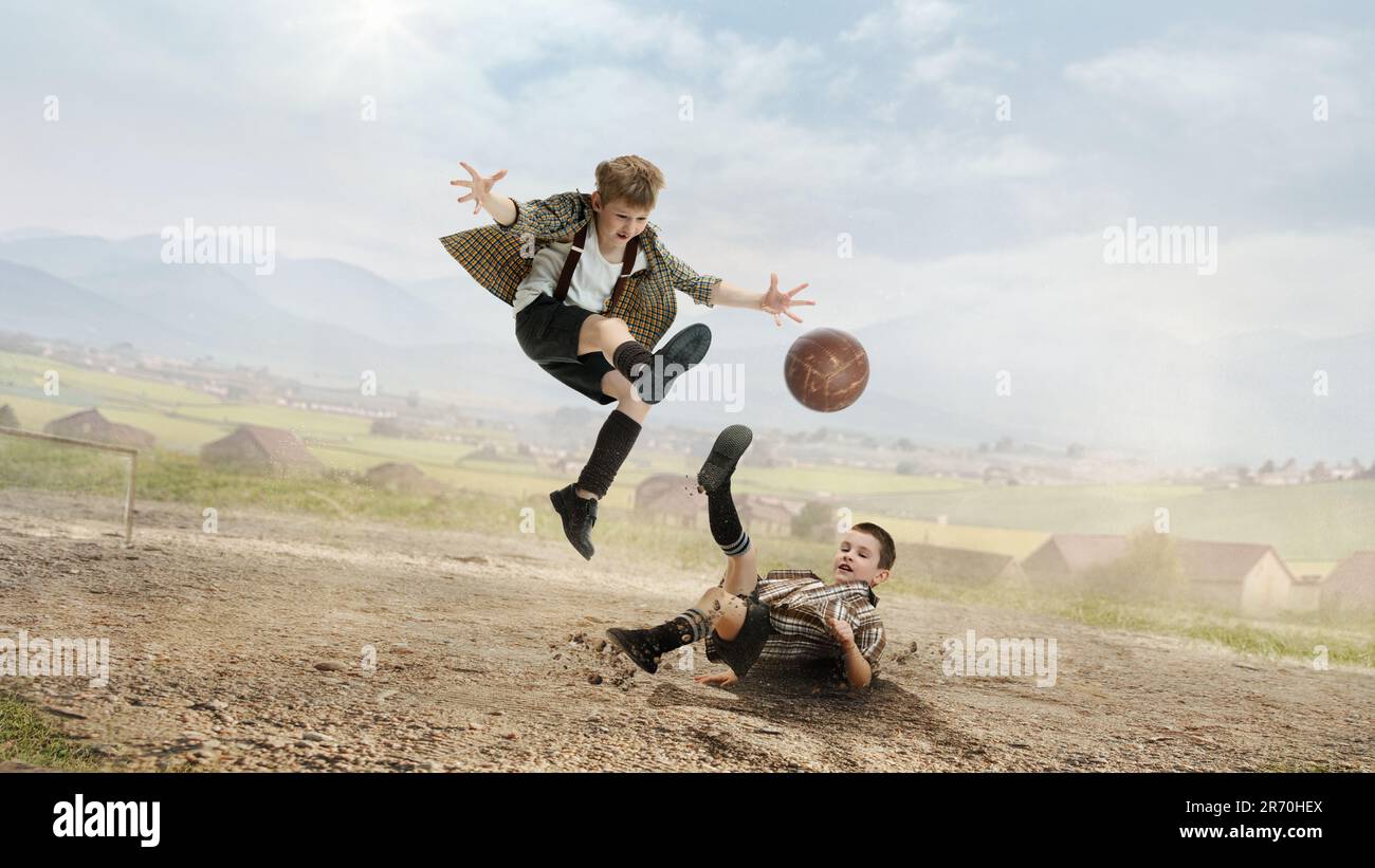 Little boys, children, brothers in retro clothes playing football ...