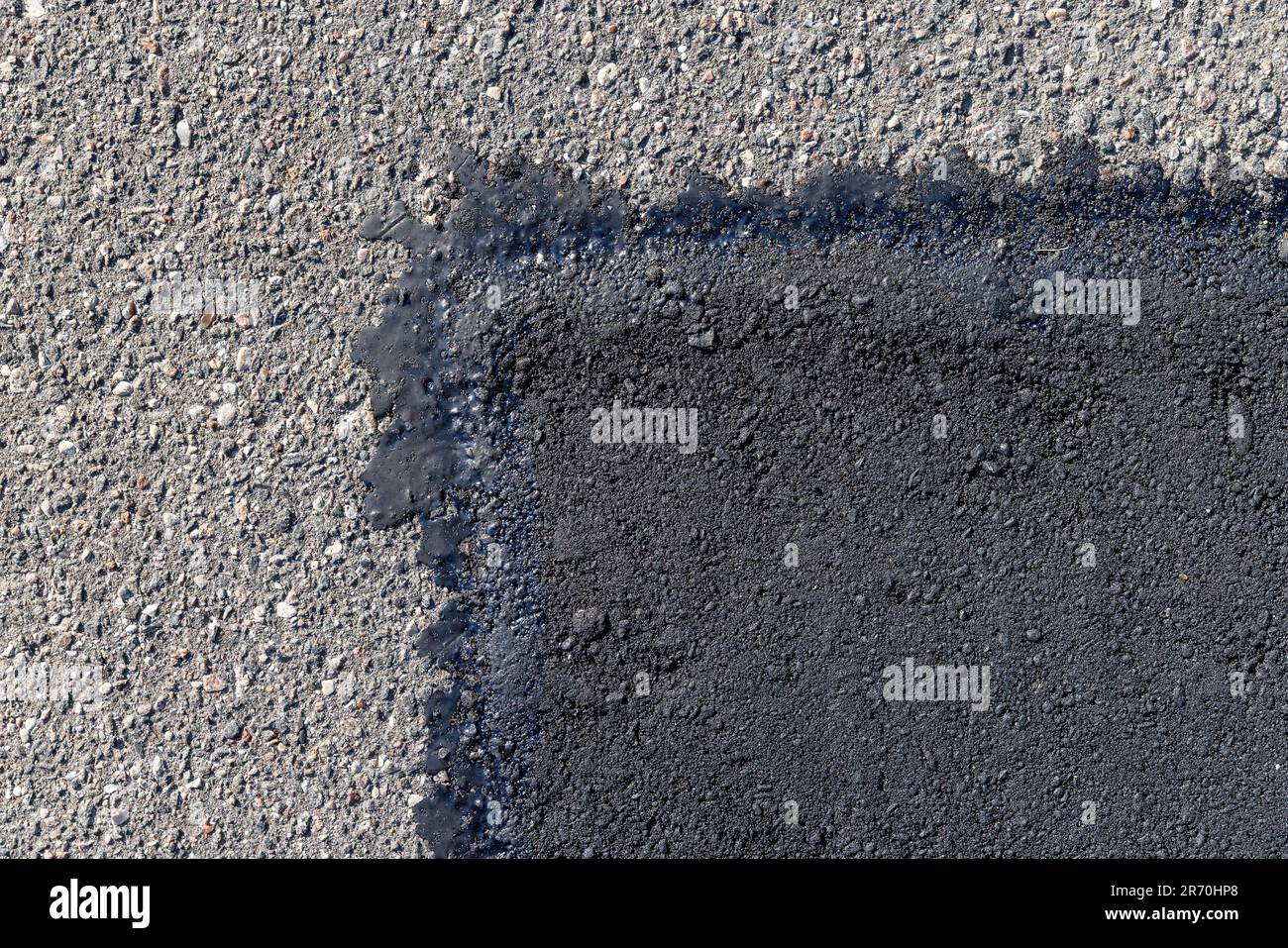 The repaired part of an asphalt road with patches, repair and ...