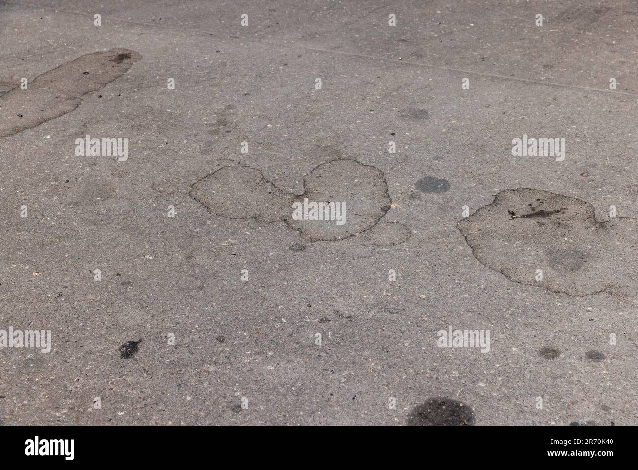 Paved road with engine oil stains and other pollution from cars, part ...