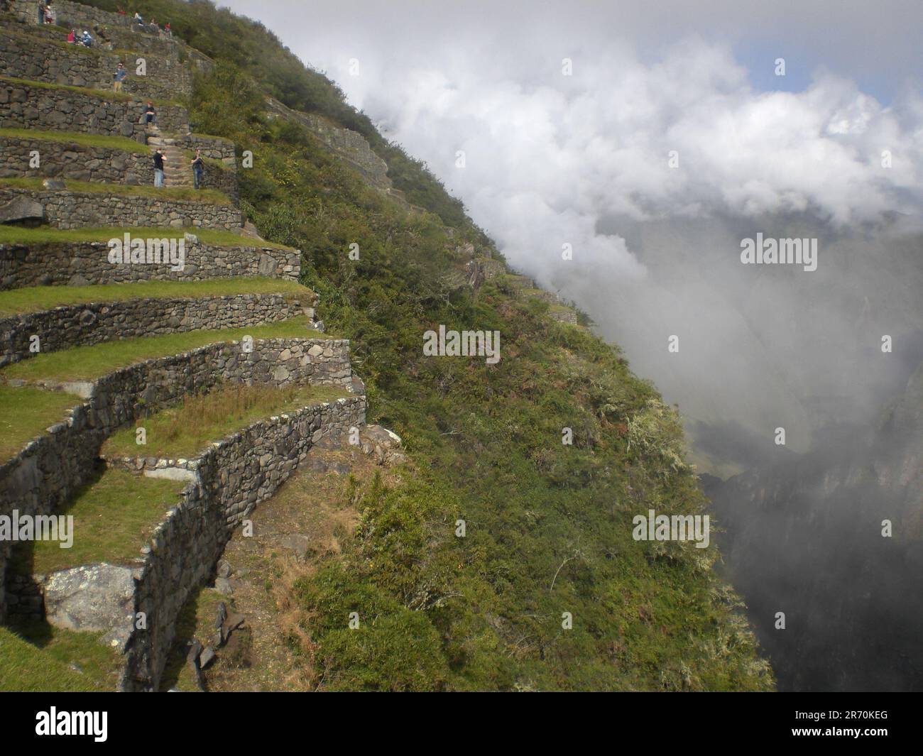 The terraces of the Inca city in Machu Picchu, Peru on a foggy day ...