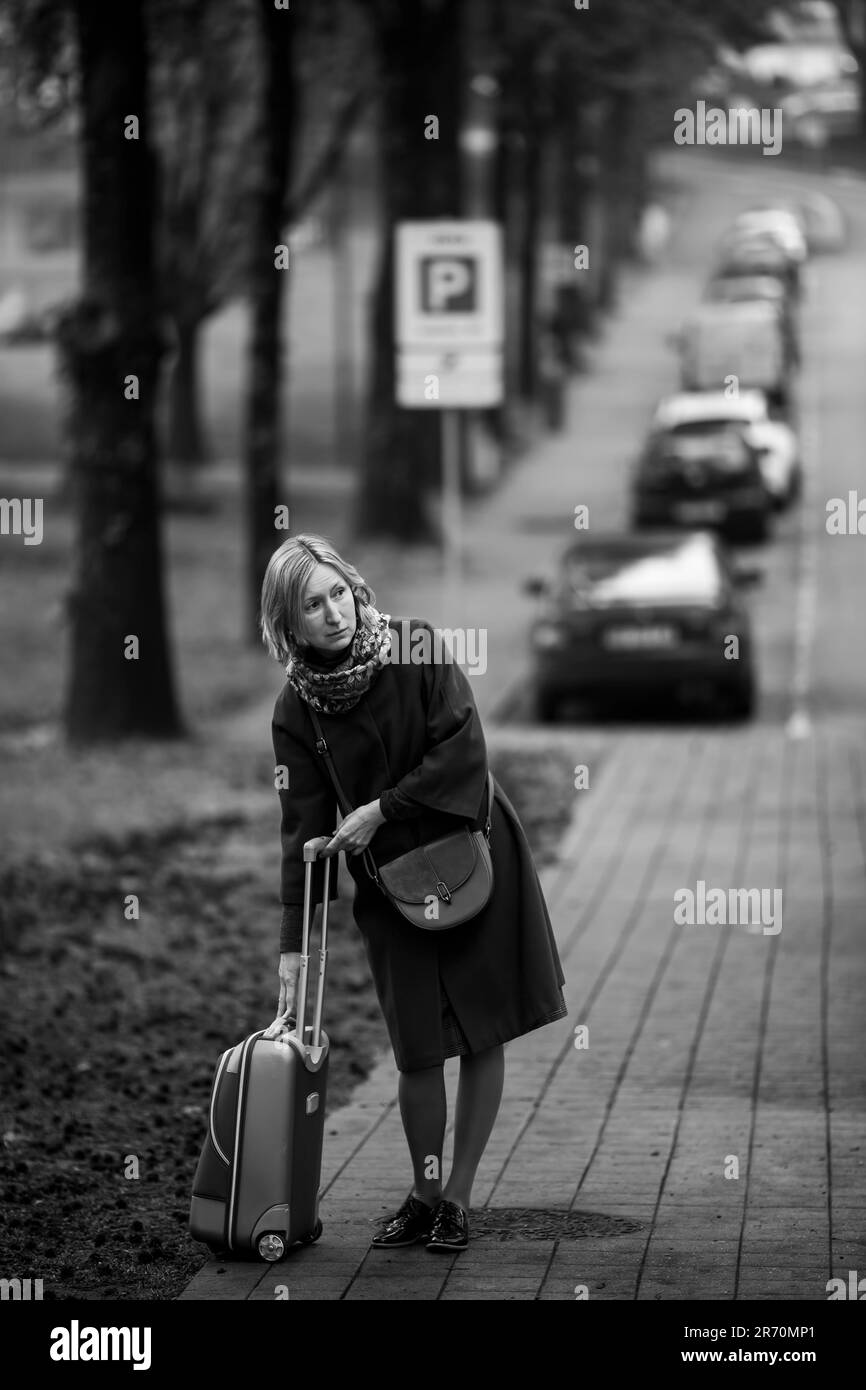 Female traveler standing suitcase Black and White Stock Photos & Images ...