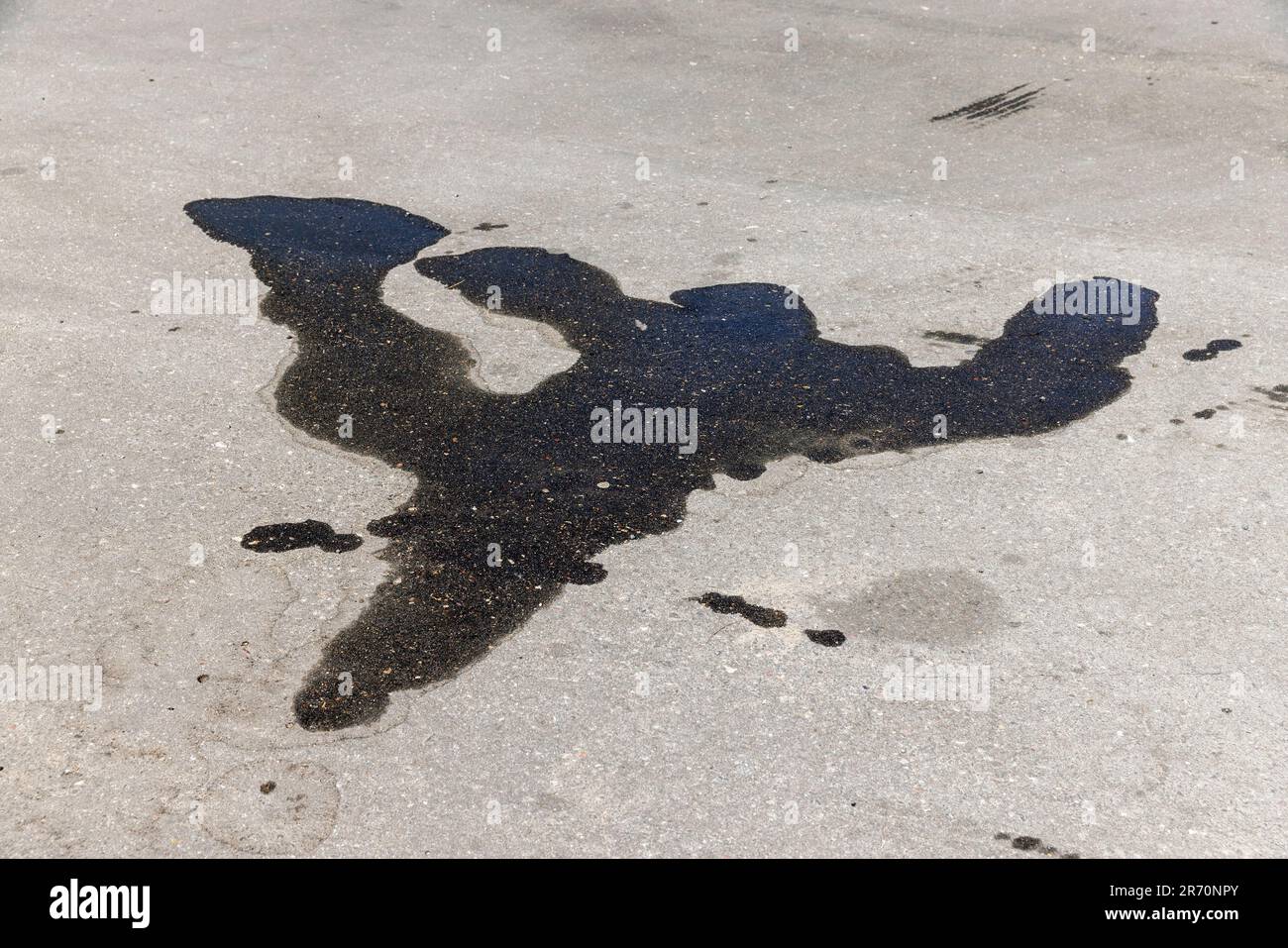 Paved road with engine oil stains and other pollution from cars, part ...