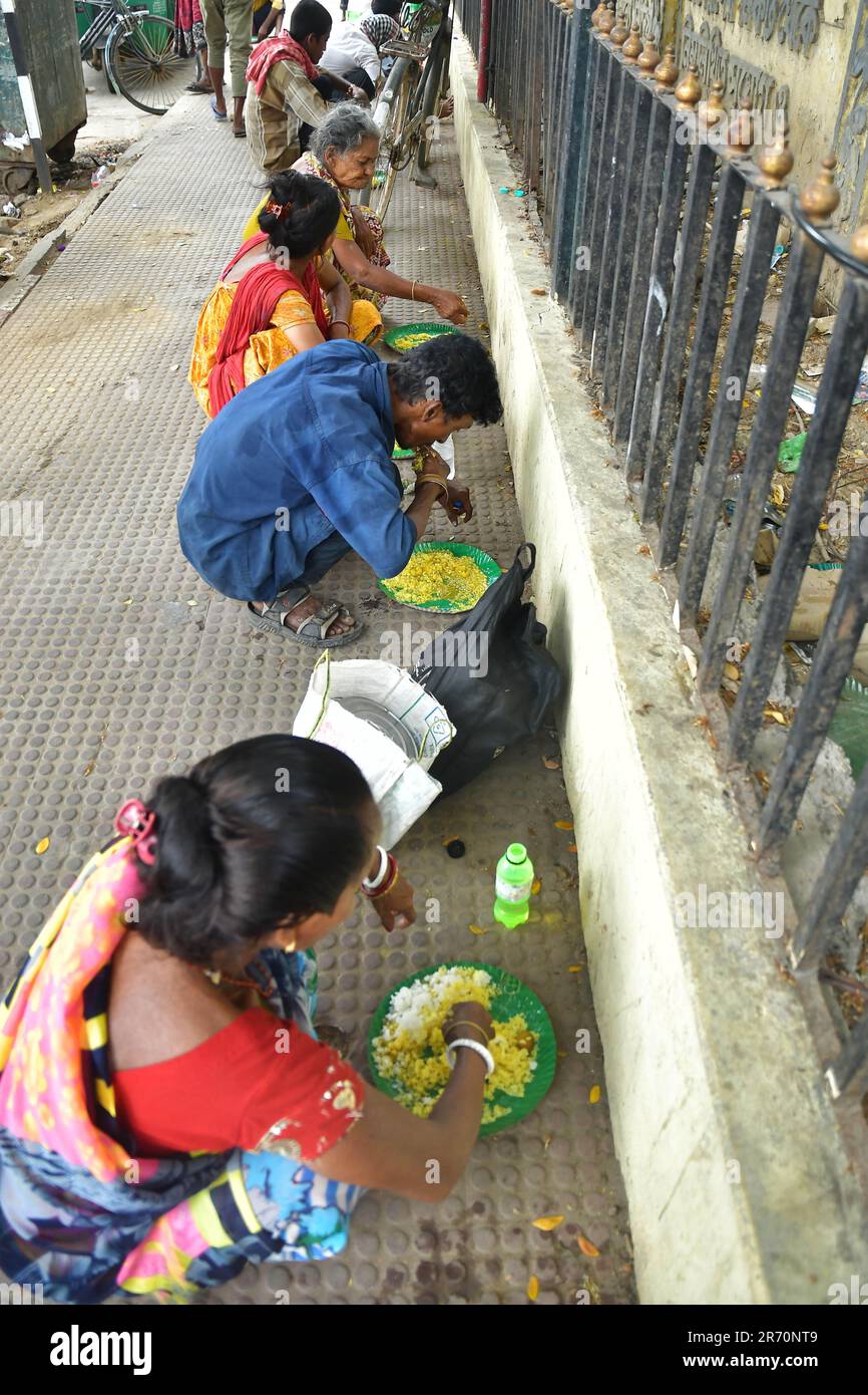 People eat food distributed by a social worker on 'World Food Safety ...