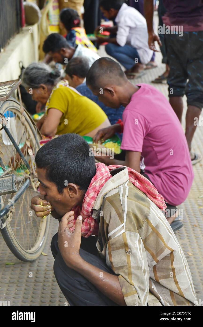 People eat food distributed by a social worker on 'World Food Safety ...