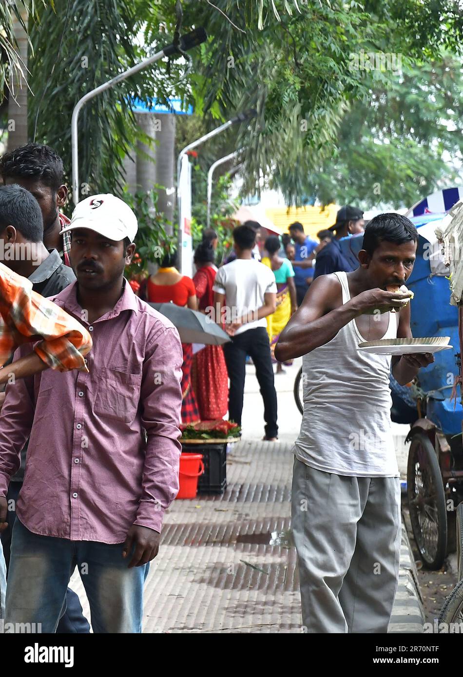 People eat food distributed by a social worker on 'World Food Safety ...