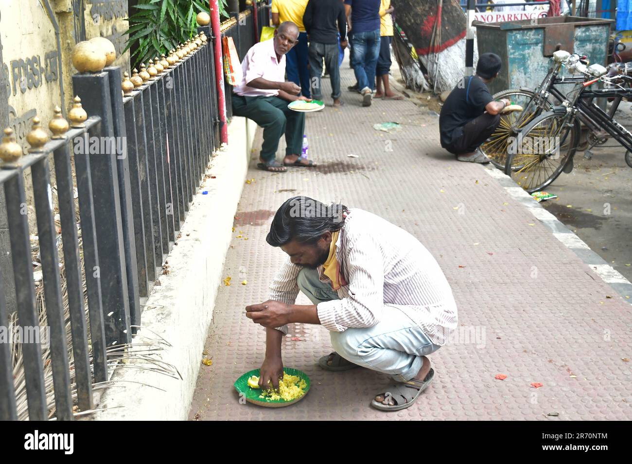 People eat food distributed by a social worker on 'World Food Safety ...