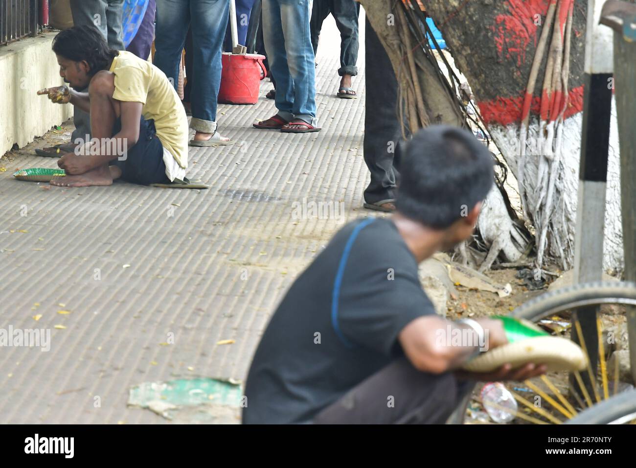 People eat food distributed by a social worker on 'World Food Safety ...