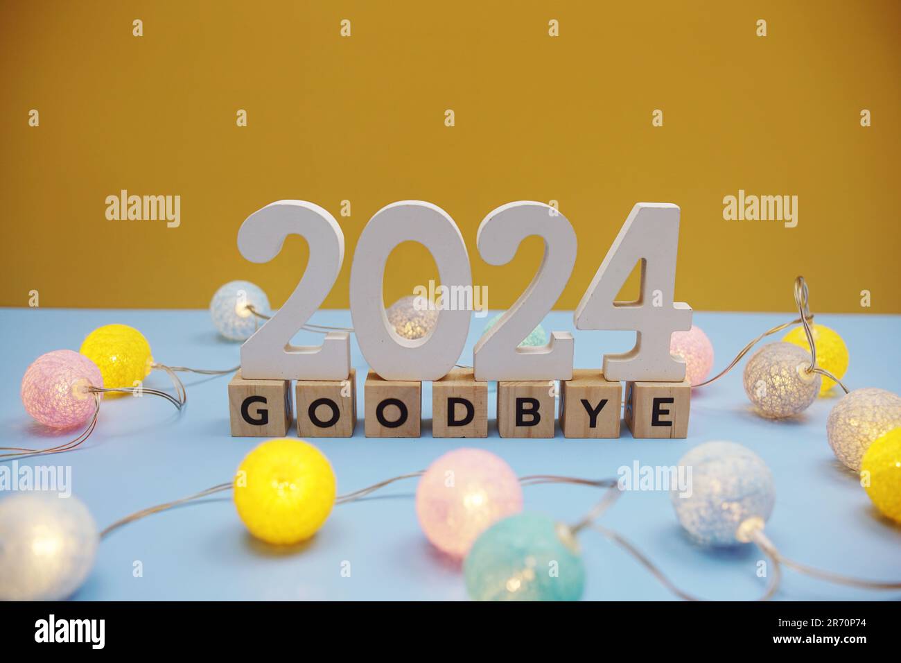 Goodbye 2024 letters with LED cotton balls decoration on blue ...